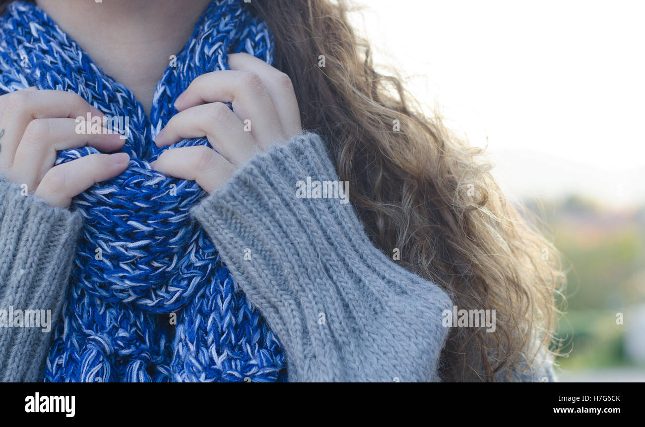 Woman putting blue scarf Stock Photo - Alamy