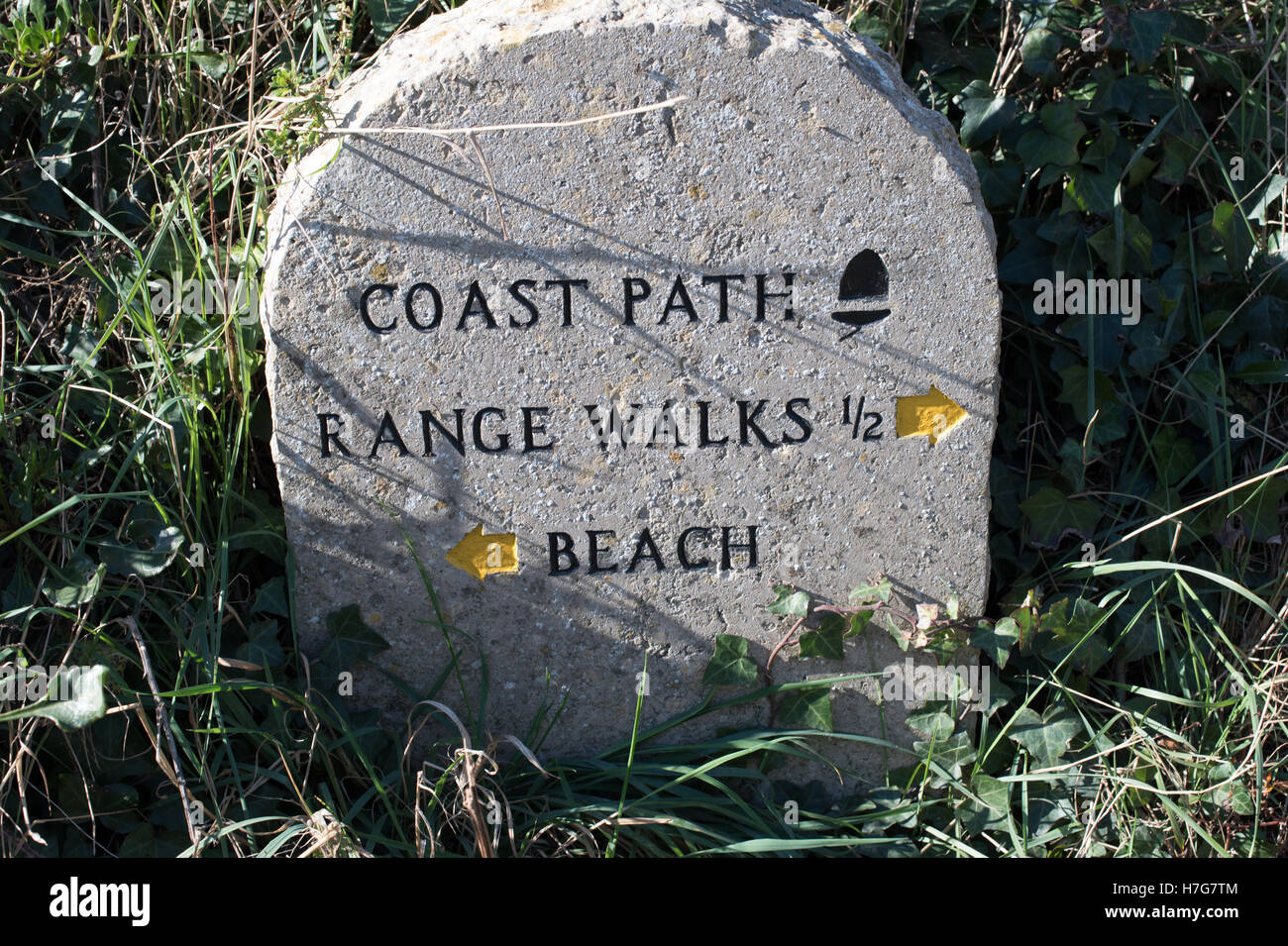 South West Coast Path directional stone, Kimmeridge Bay, Dorset Stock ...