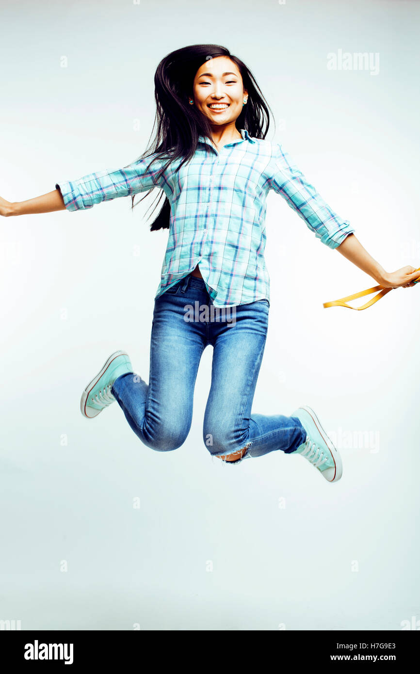 cute pretty young asian girl jumping on white background, lifestyle ...