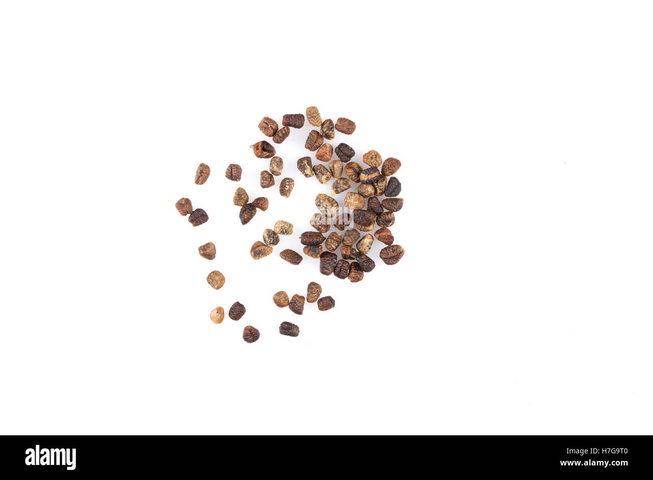 Decorticated cardamom seeds pile on a white background Stock Photo - Alamy