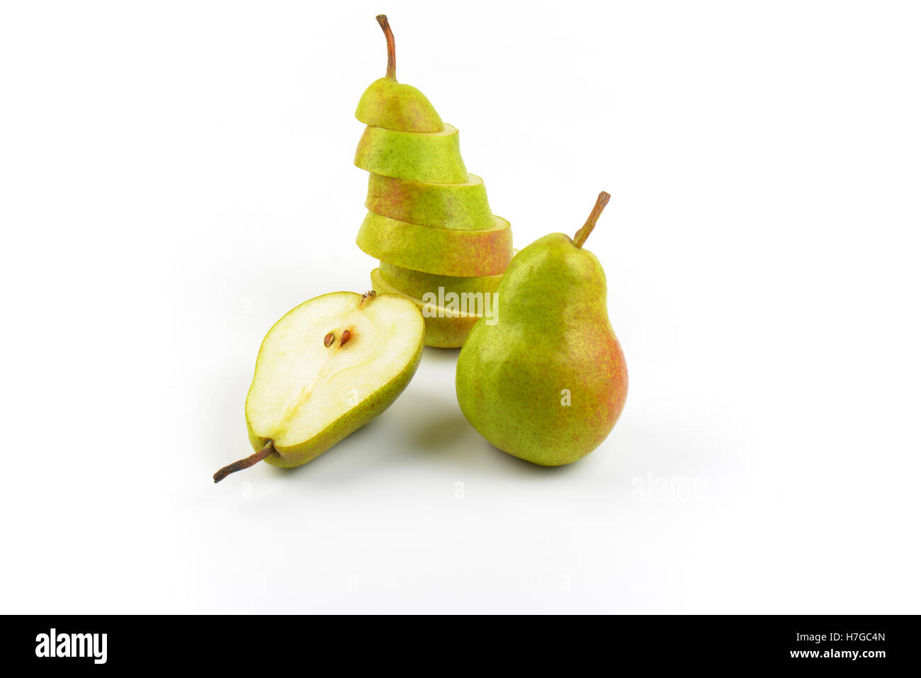whole, halved and sliced pears on white background Stock Photo - Alamy