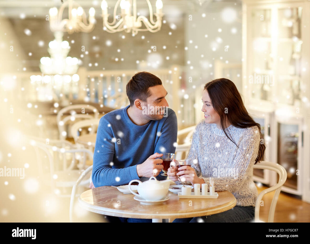 happy couple drinking tea at cafe Stock Photo - Alamy