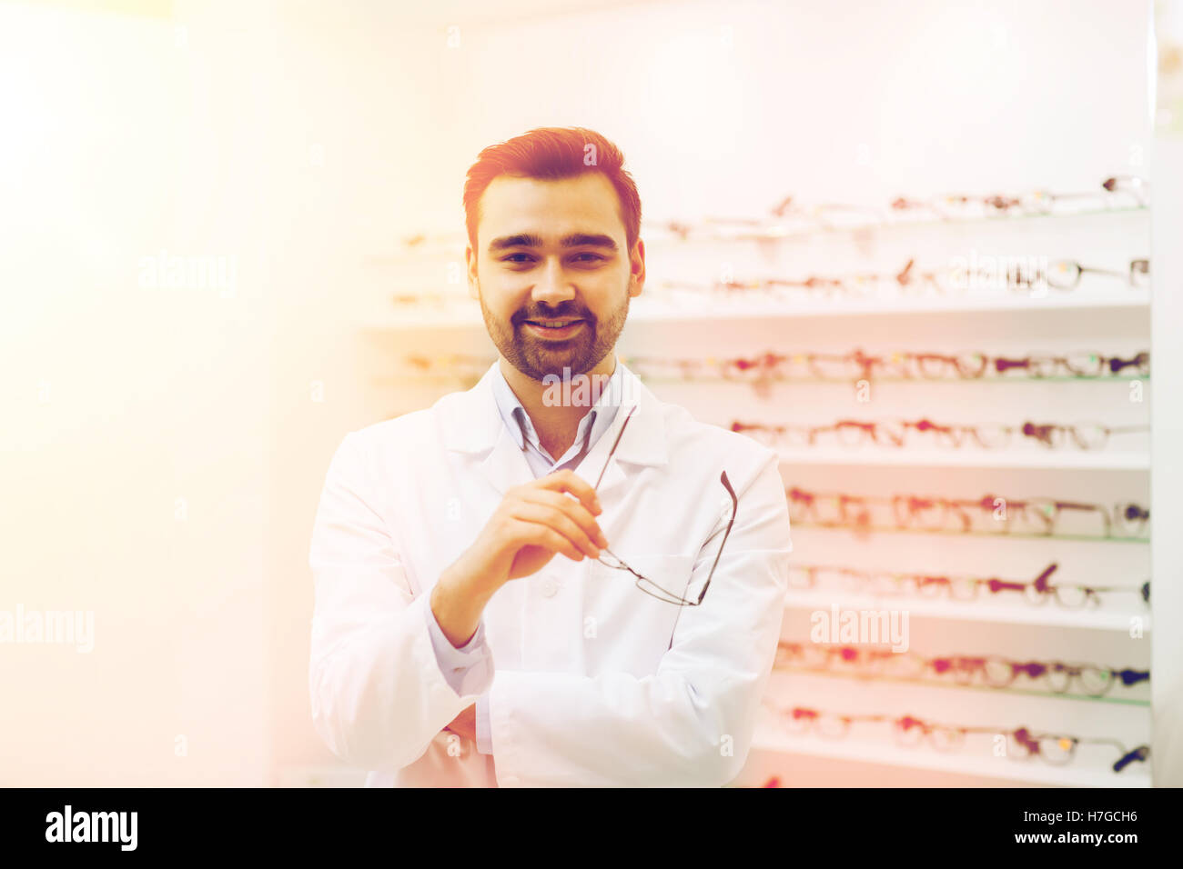 man optician with glasses in coat at optics store Stock Photo - Alamy
