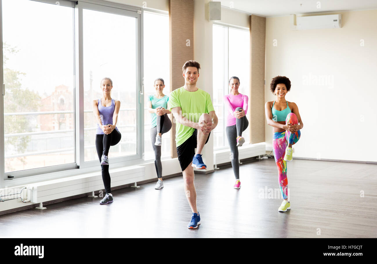 group of smiling people exercising in gym Stock Photo - Alamy