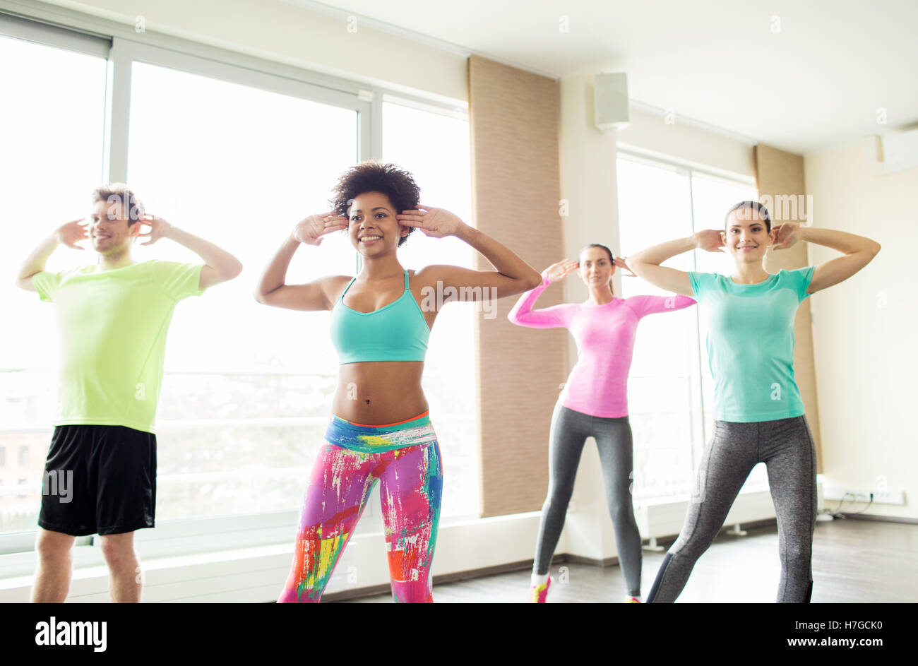 group of smiling people dancing in gym or studio Stock Photo - Alamy