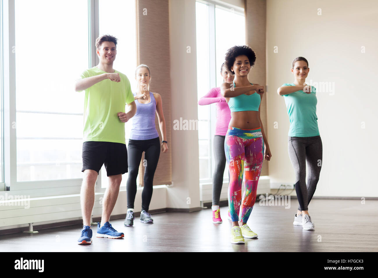 group of smiling people dancing in gym or studio Stock Photo - Alamy