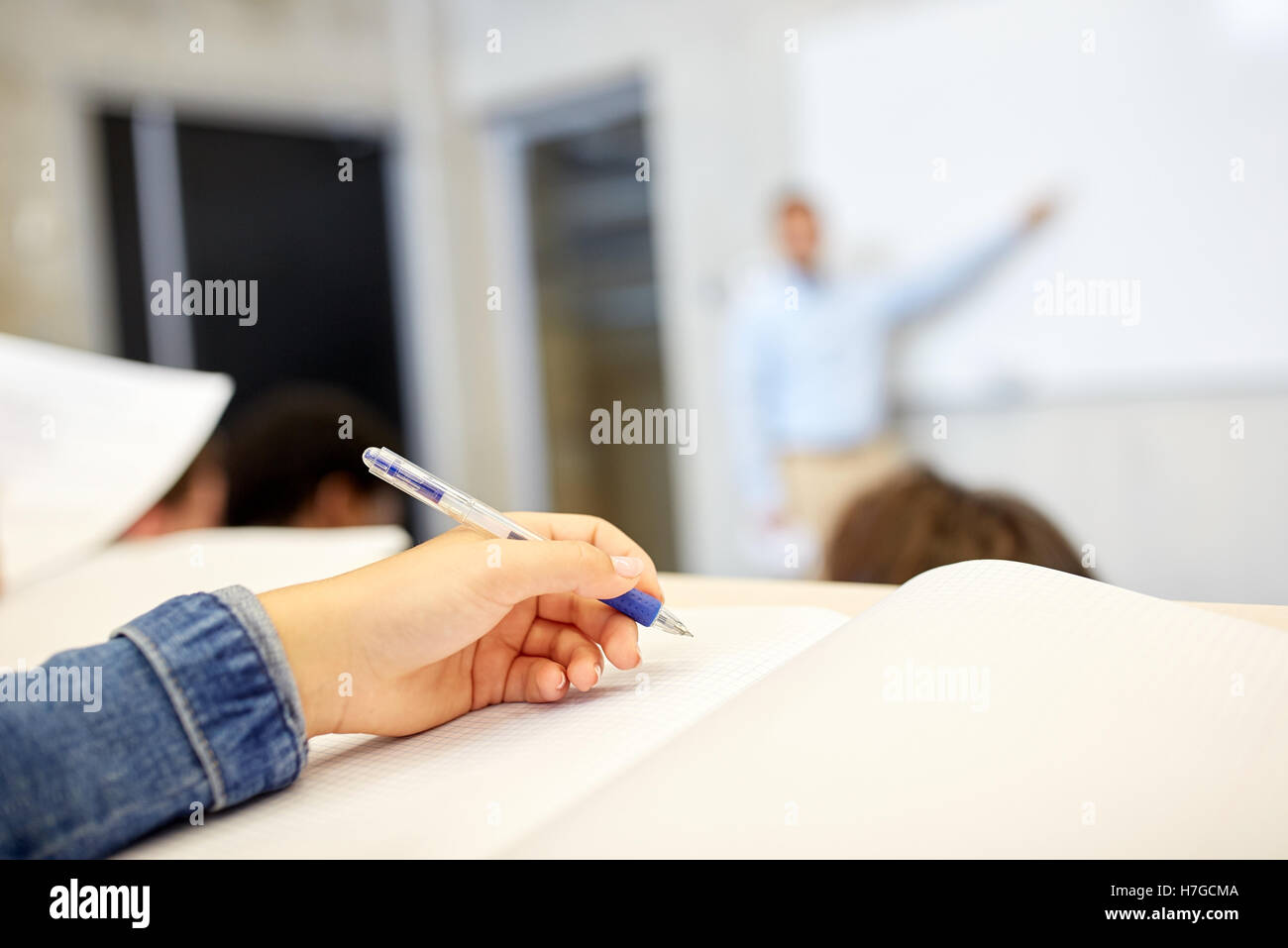 student hand writing to notebook at lecture Stock Photo - Alamy