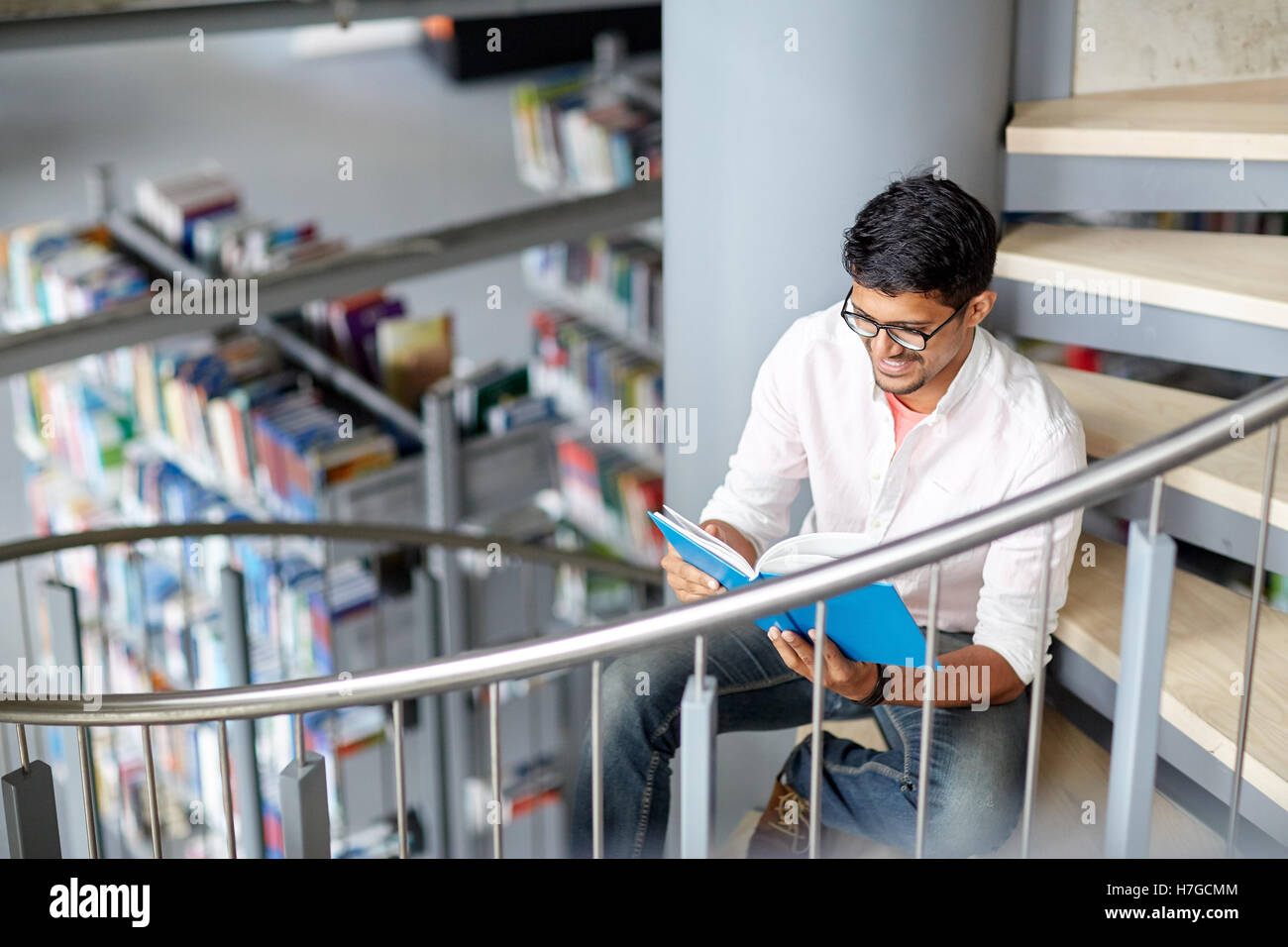 Indian student reading book hi-res stock photography and images - Alamy