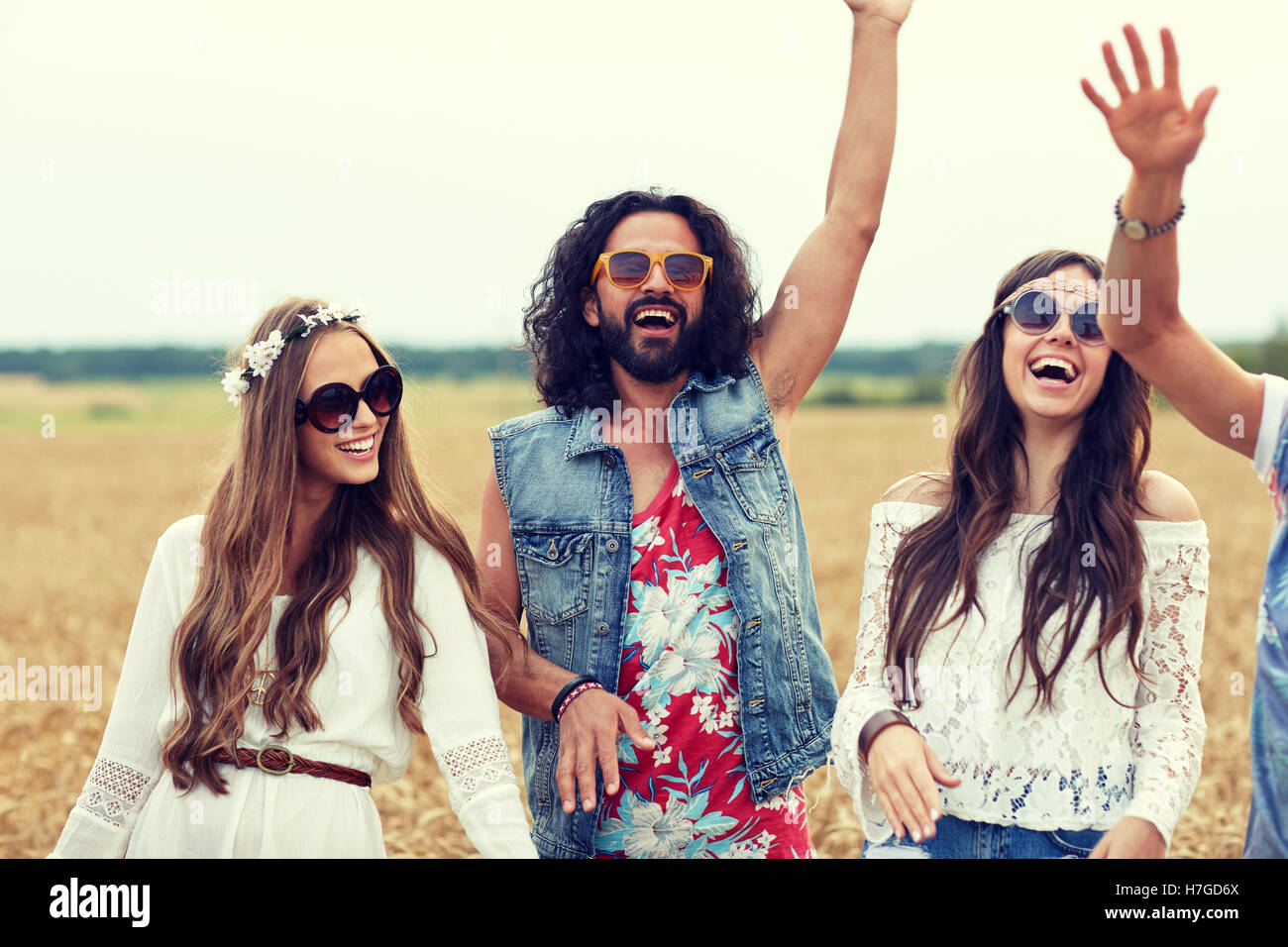 happy young hippie friends dancing on cereal field Stock Photo - Alamy