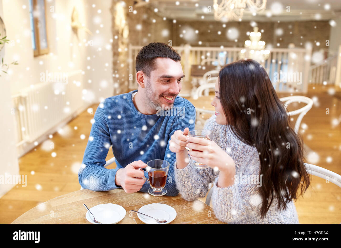 happy couple drinking tea at cafe Stock Photo - Alamy