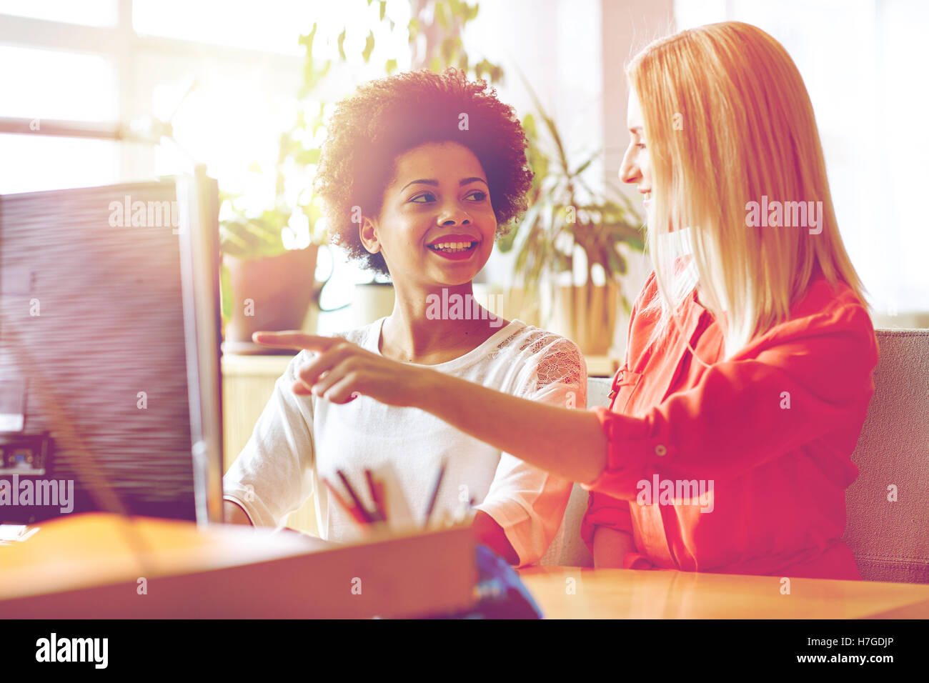 happy women or students with computer in office Stock Photo - Alamy