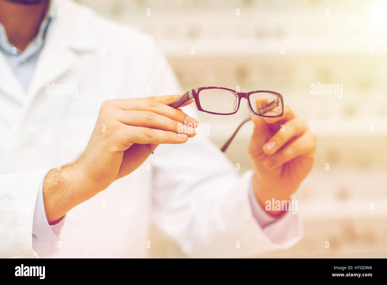 close up of optician with glasses at optics store Stock Photo - Alamy