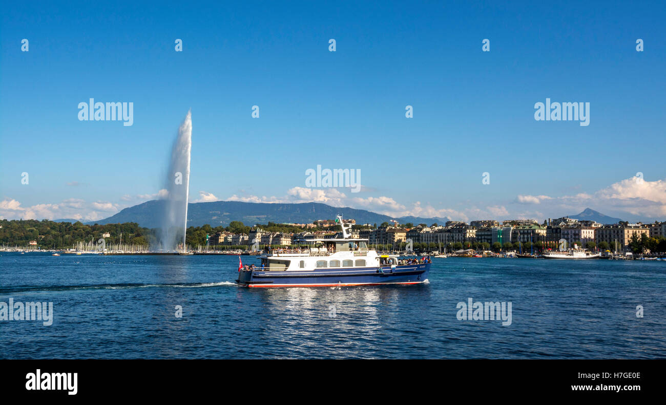 Cruise vessel sailing past Le Jet d'Eau in Geneva on a bright sunny day ...