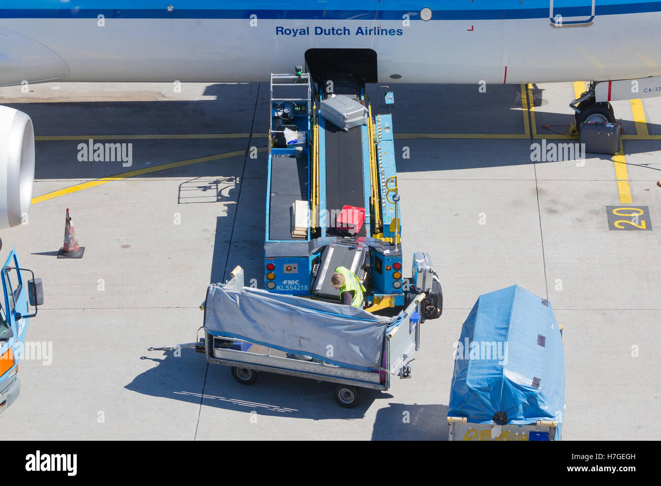 AMSTERDAM, NETHERLANDS - AUGUST 17, 2016: Loading luggage in airplane ...