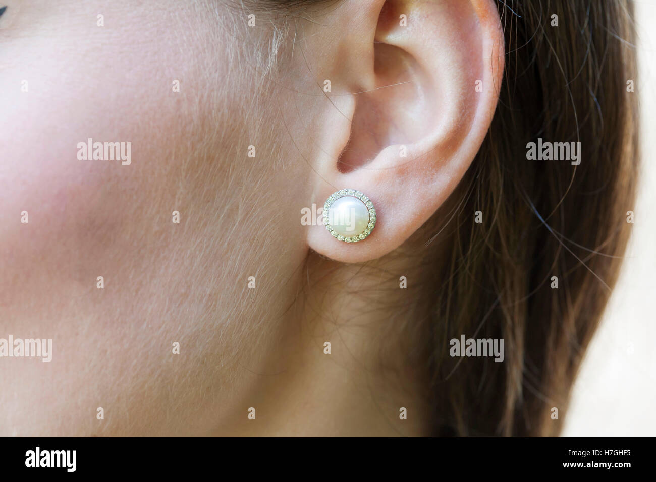 Woman's ear wearing an earring Stock Photo - Alamy