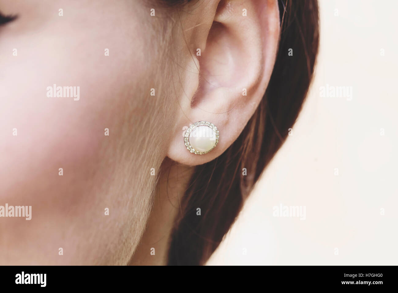 Woman's ear wearing an earring Stock Photo - Alamy