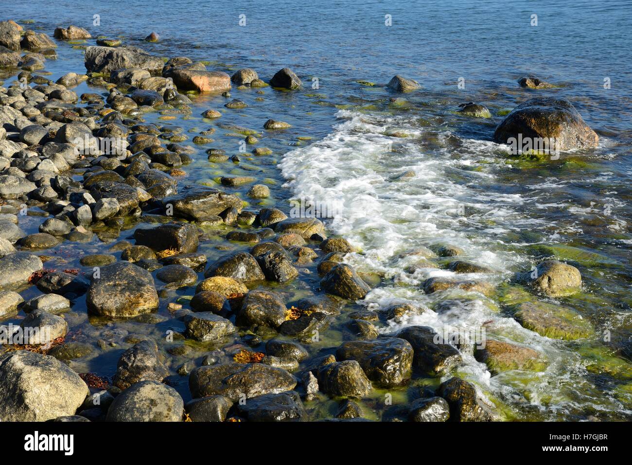 Waves on stone beach Stock Photo - Alamy