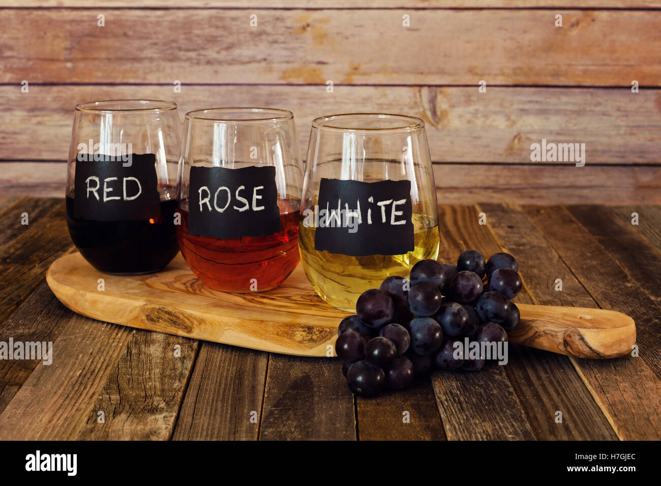 Three color wine flight in label glasses Stock Photo - Alamy
