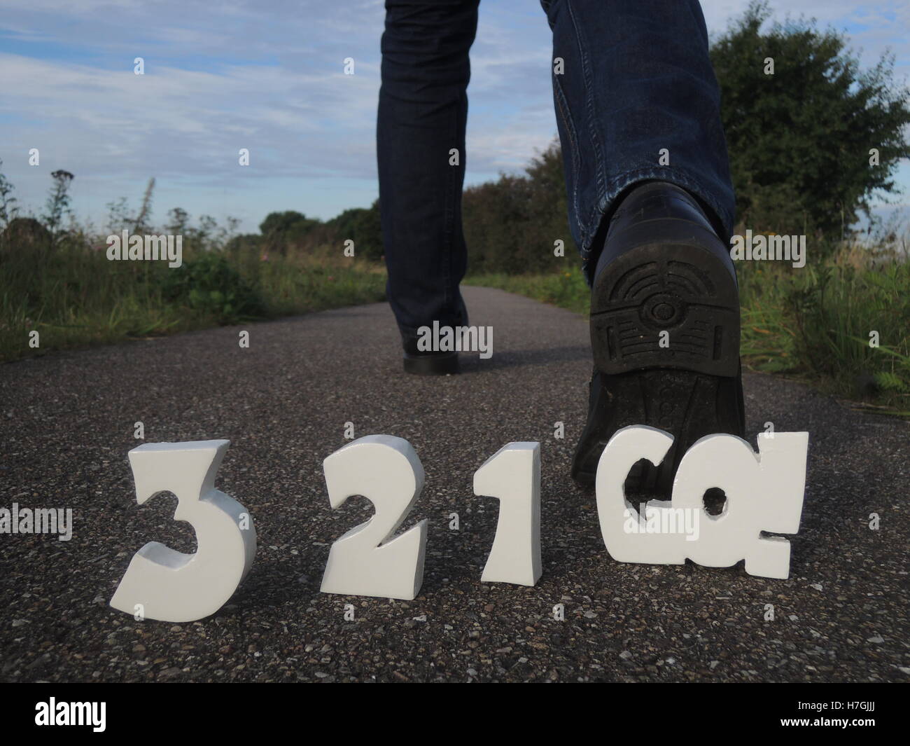 3D letters counting down 3-2-1-go! behind man walking hastingly ahead ...