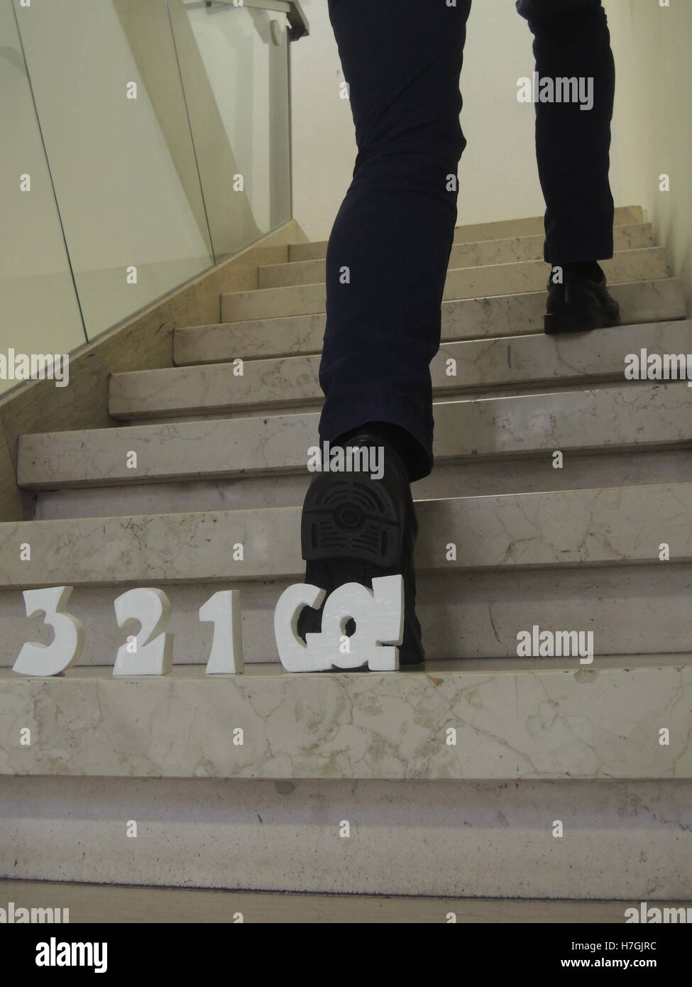 3D letters counting down 3-2-1-go! behind man leaping hastingly up the ...