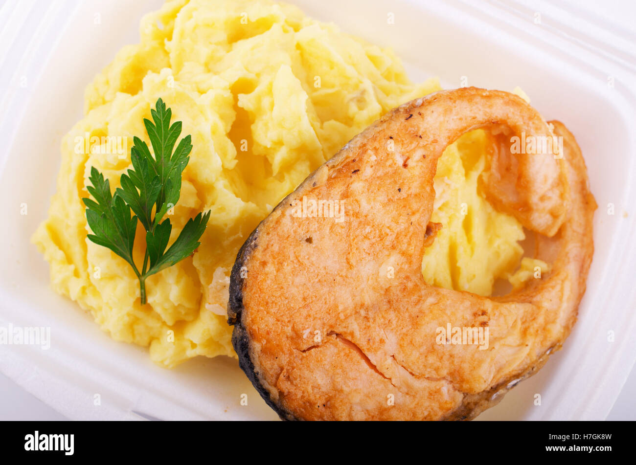 Fried fish with mashed potatoes on plastic plate Stock Photo - Alamy