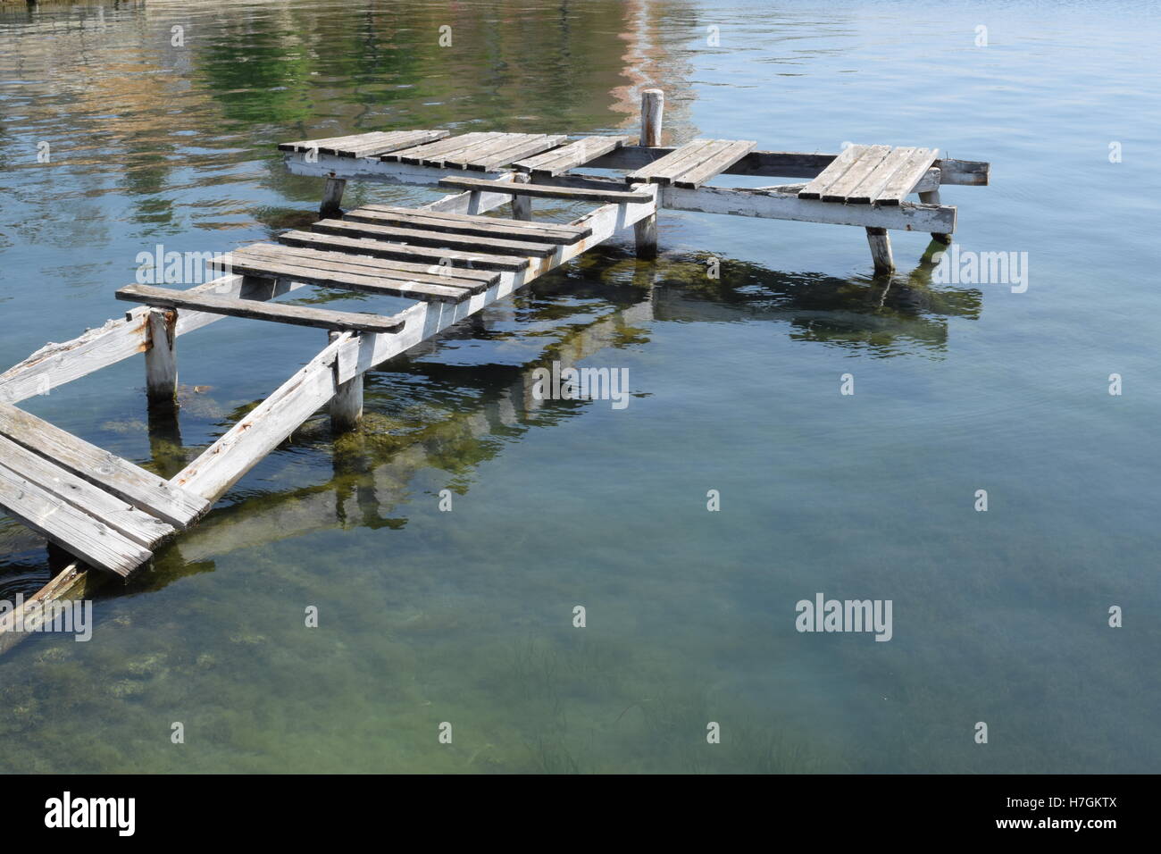 Old rotten boat bridge in a ghost town Stock Photo - Alamy