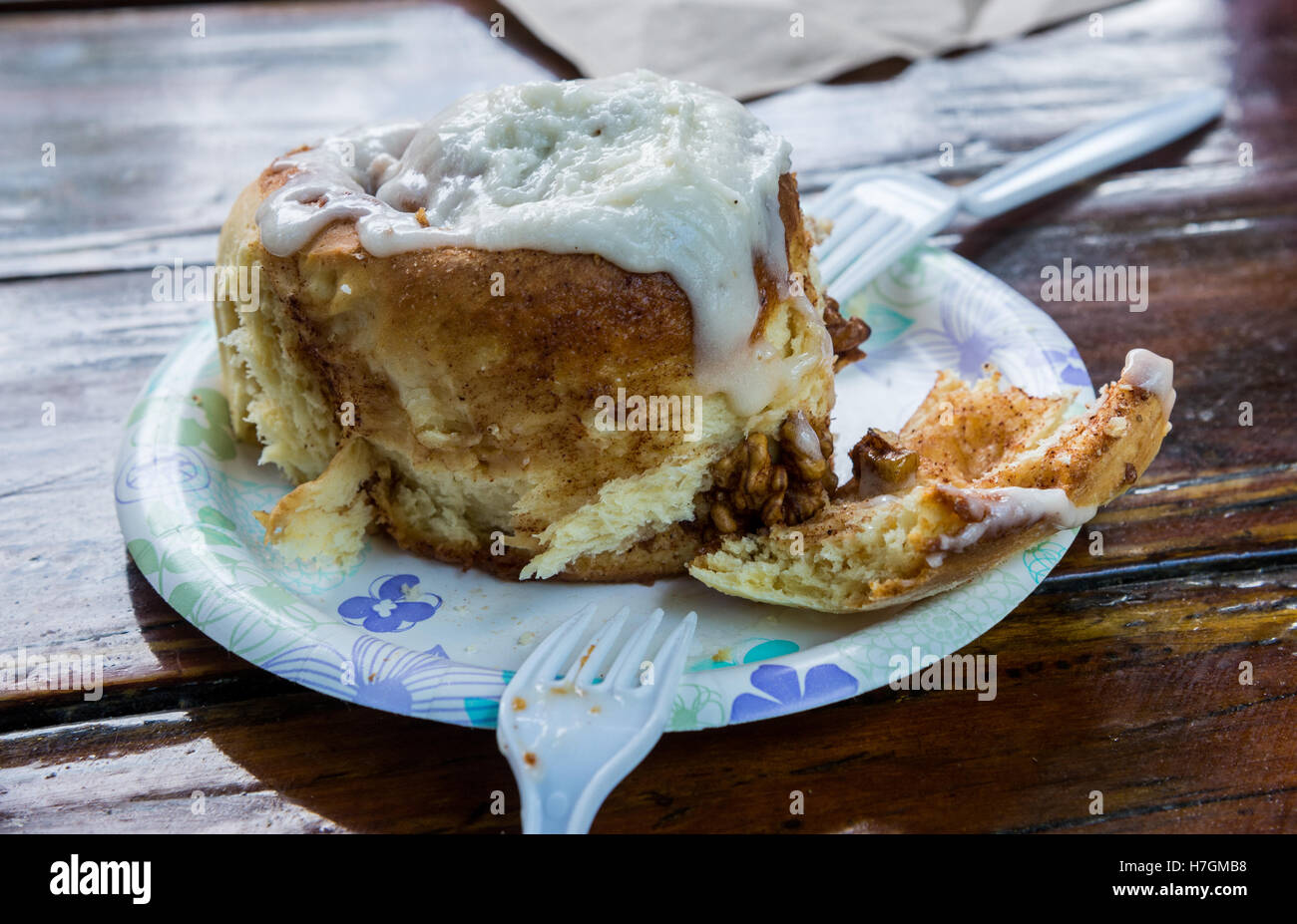 A cinnamon bun on a paper plate, a traditional sweet snack in United ...