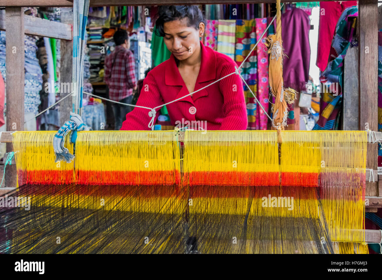 Textile worker on loom in city of Pokhara Nepal Stock Photo - Alamy