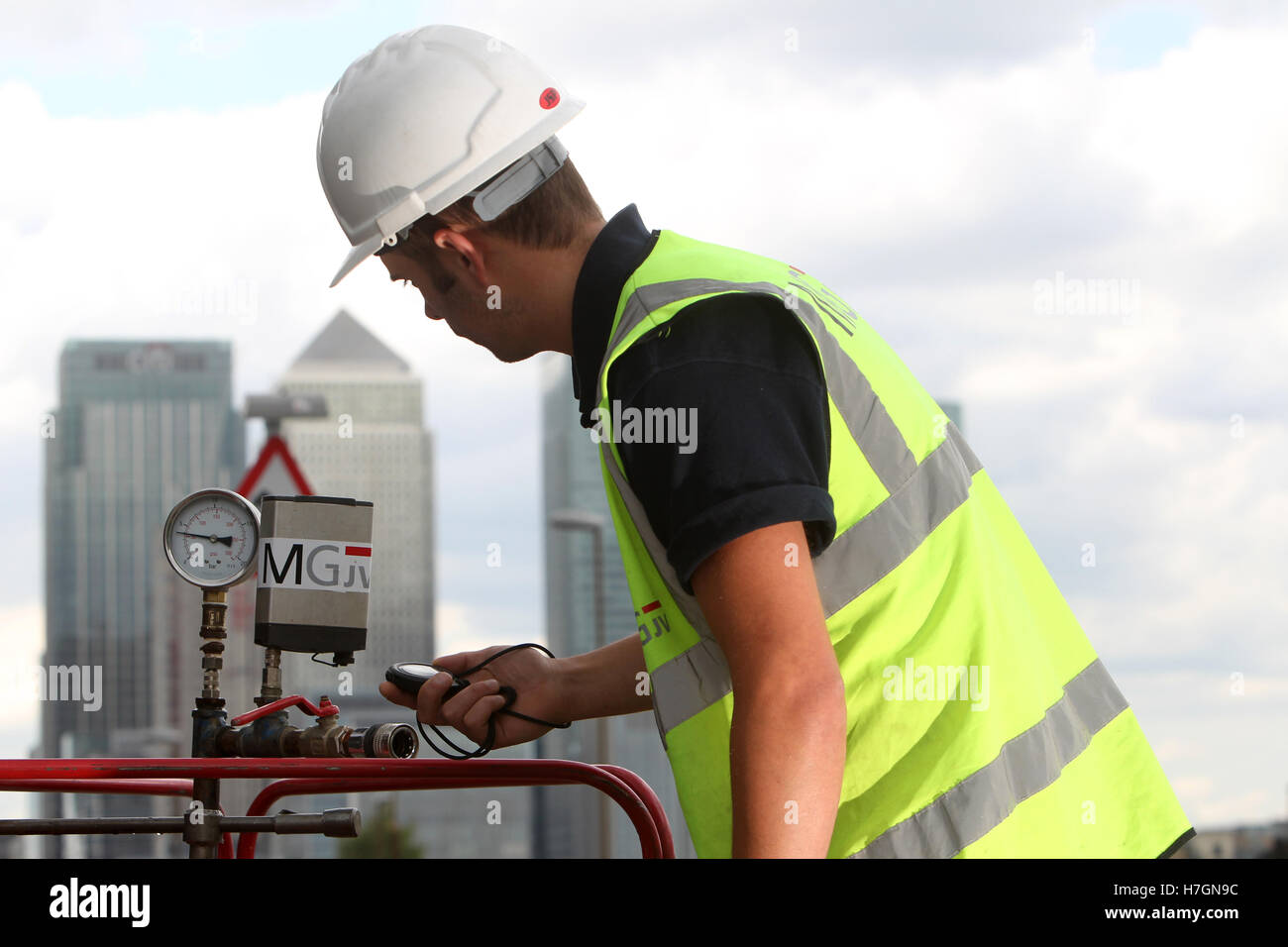 waste water workers checking valves with London skyline in background ...