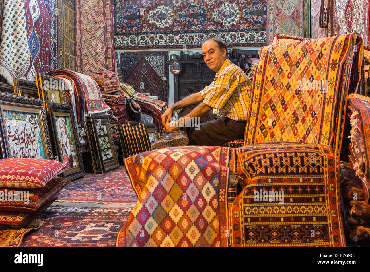 Man selling carpets in iran Stock Photo - Alamy