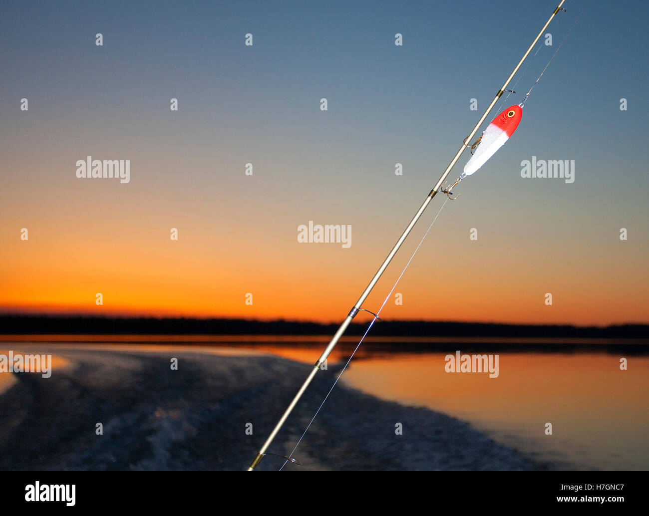 Twilight fishing rod and lure on a lake in Saskatchewan Canada Stock ...