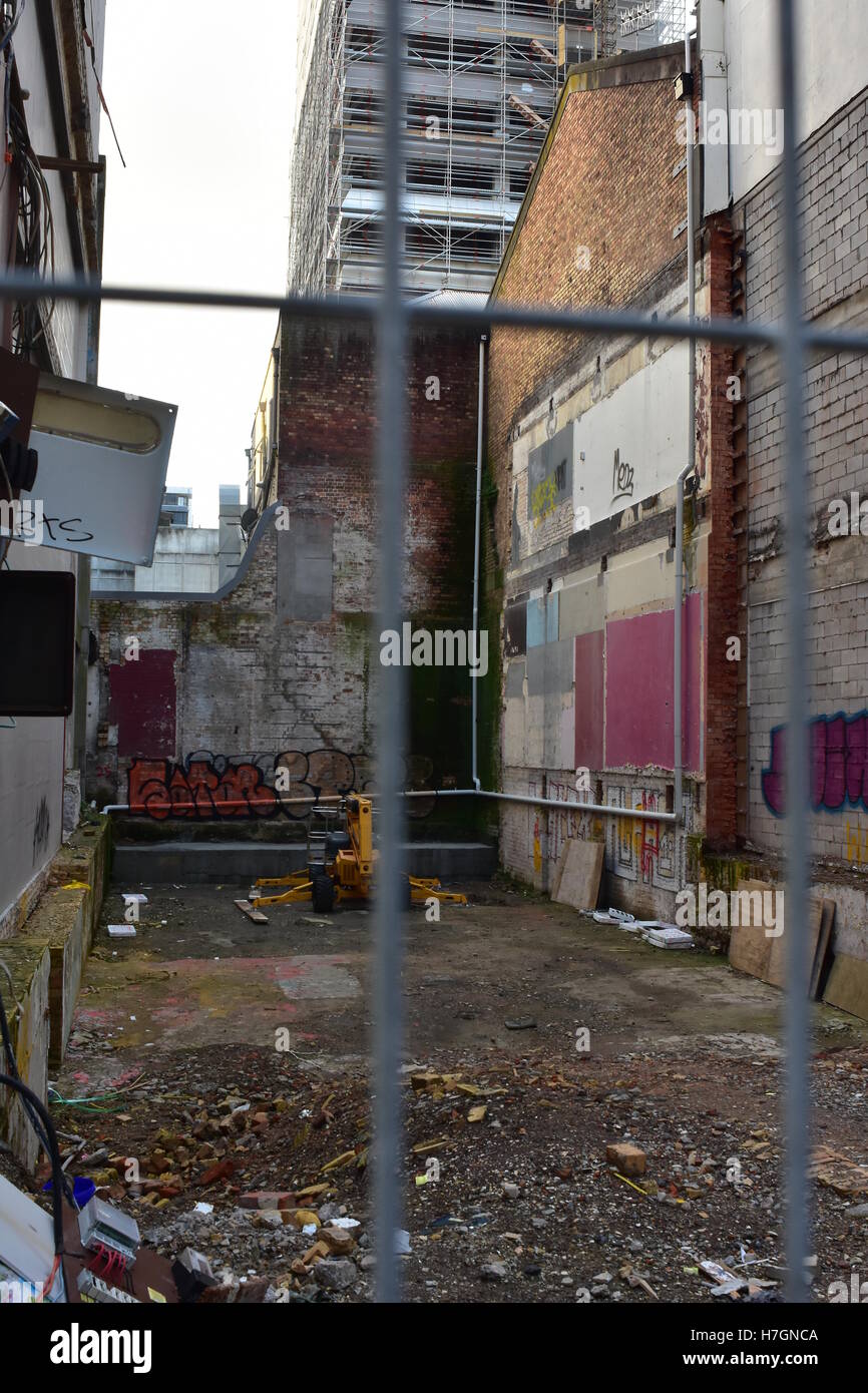 Rubbish and rubble gathering in an empty plot between buildings in ...