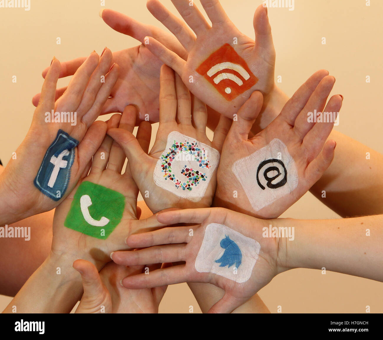 Hands together with social media logos Stock Photo - Alamy