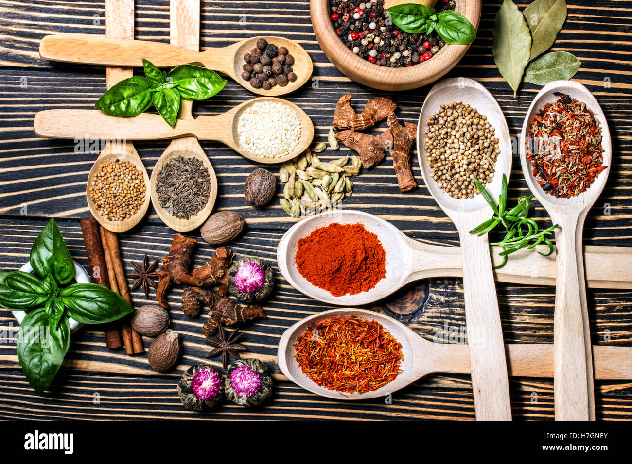 Colorful aromatic spices and herbs on an old oak wooden brown ...