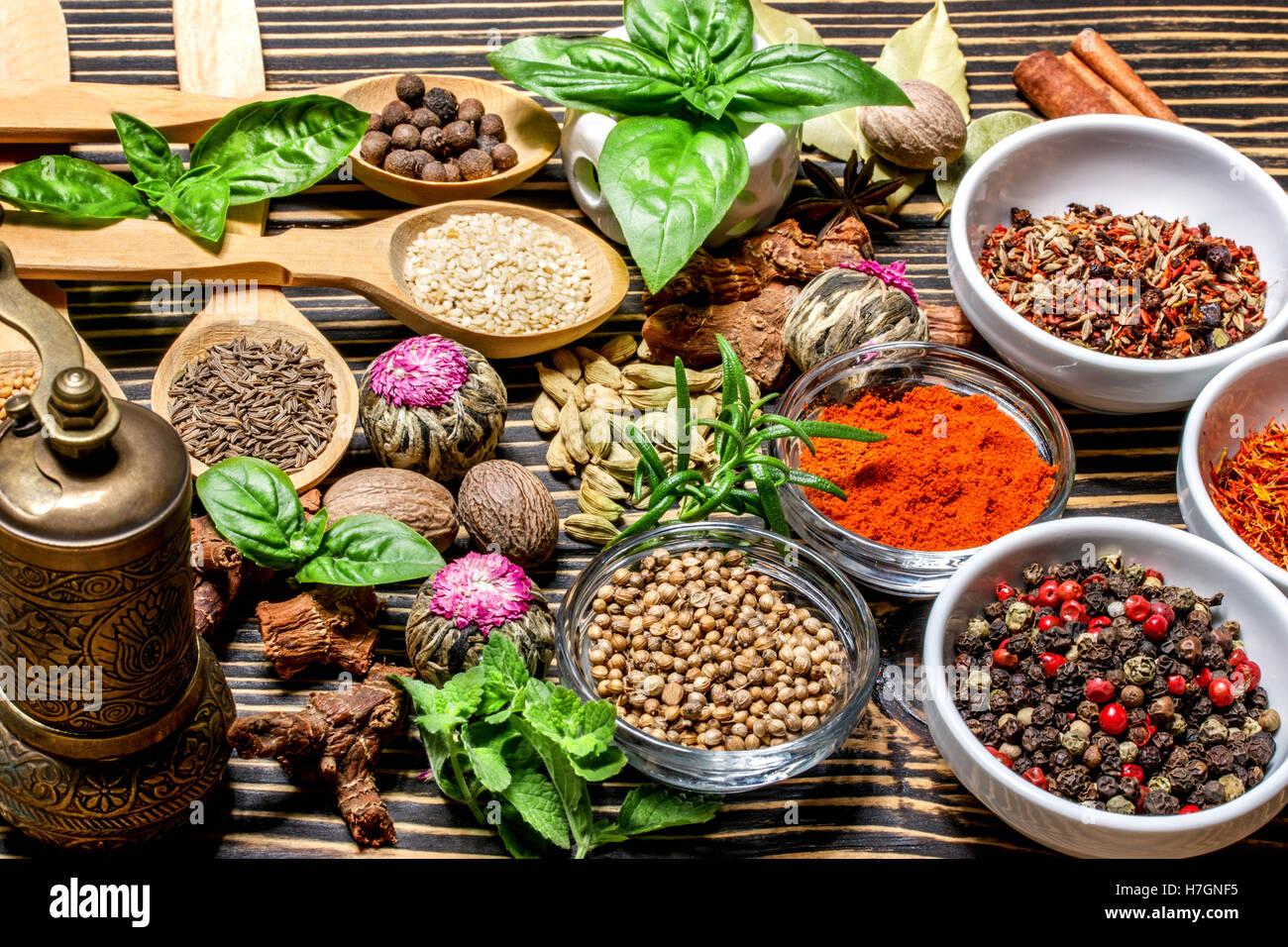 Colorful aromatic spices and herbs on an old oak wooden brown ...