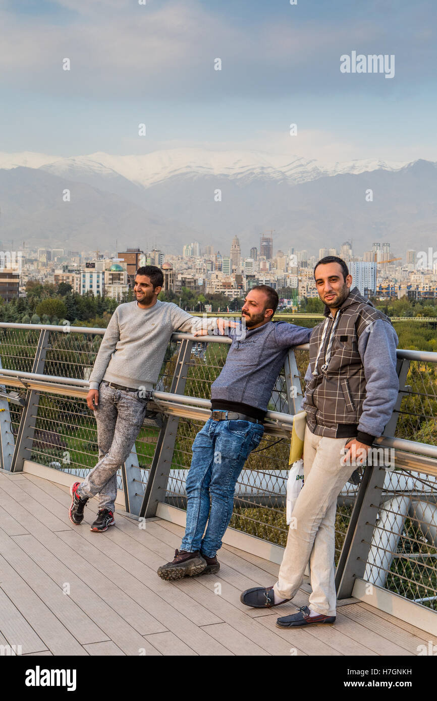 iranian men standing on the tabiat bridge with view of city in ...