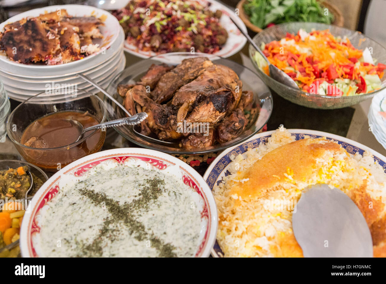 many dishes of a traditional iranian meal including chicken and rice ...