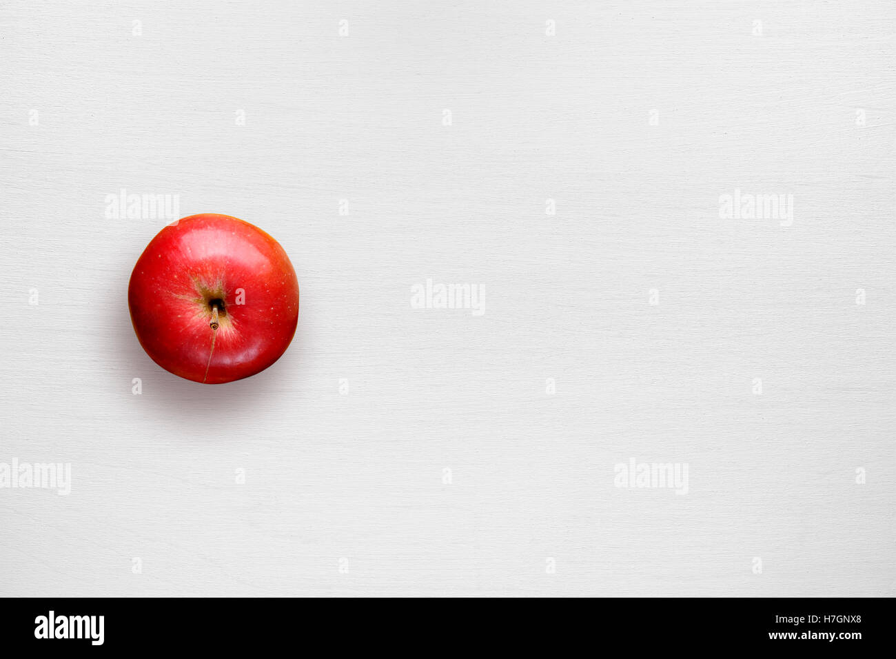 Red apple on white table top view Stock Photo - Alamy