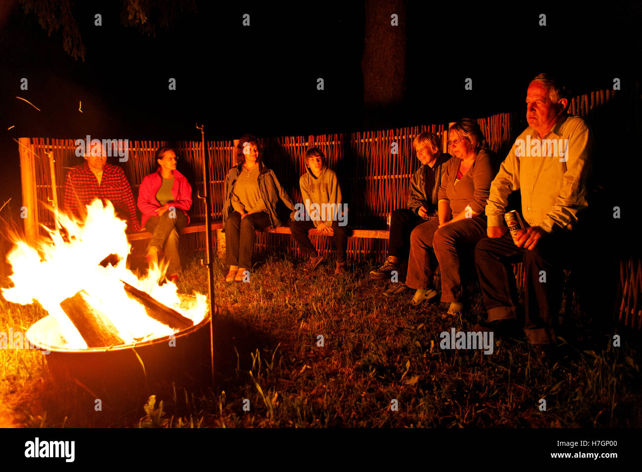 People sitting at campfire at night in Latgale Latvia Stock Photo - Alamy