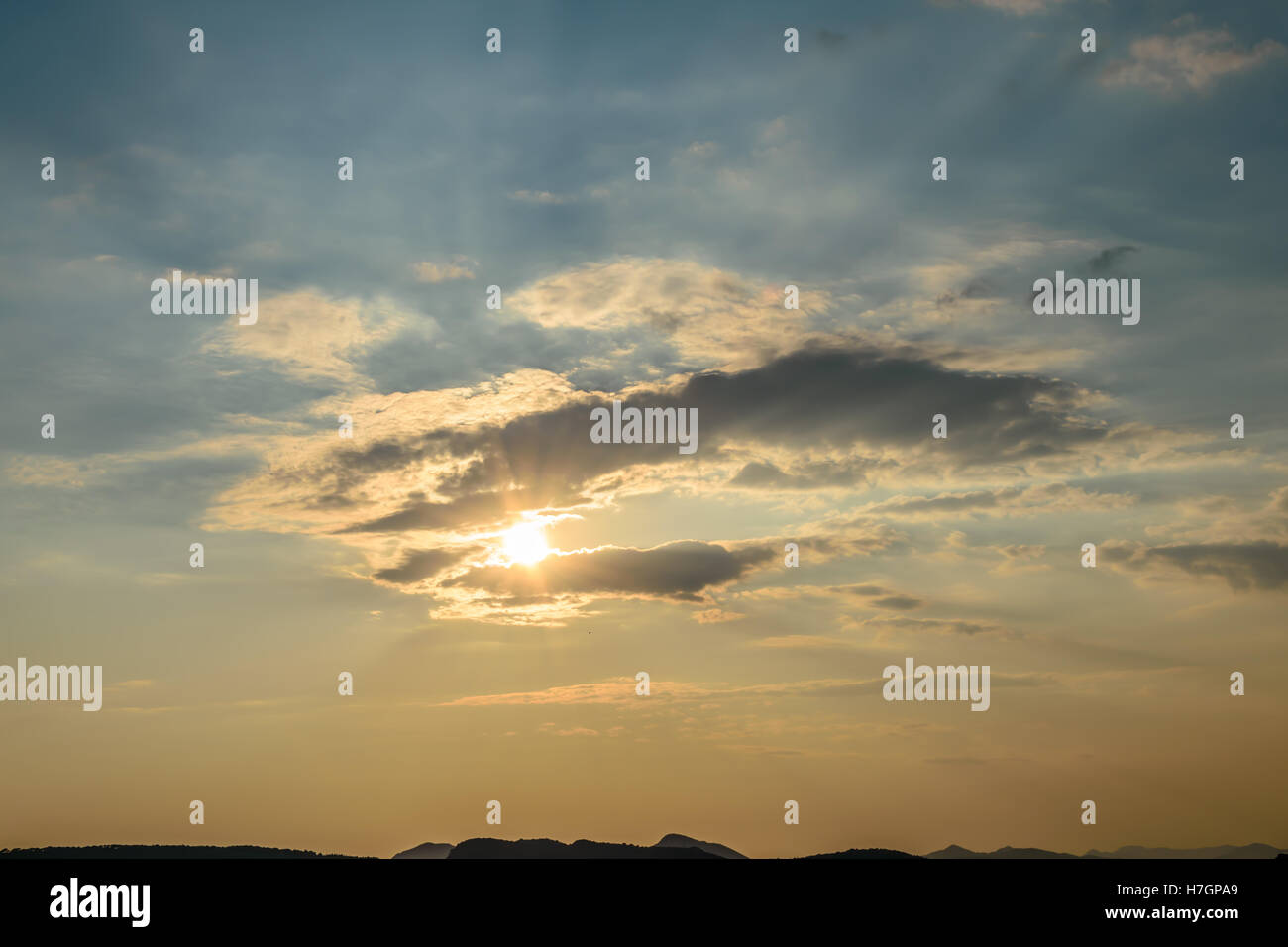 Sun behind clouds Stock Photo - Alamy