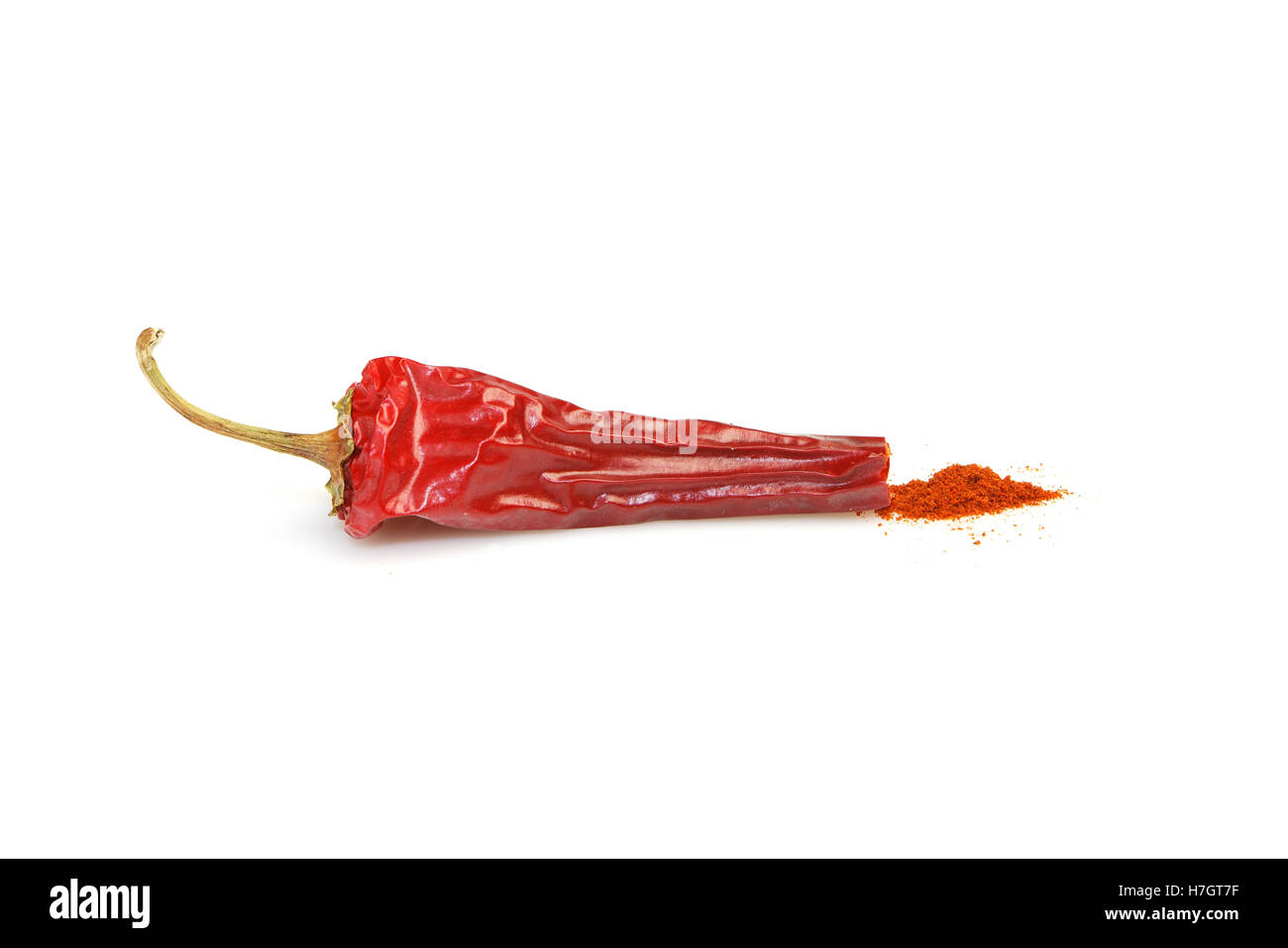 Hot red paprika on white background, cut and filled with powdered spice ...