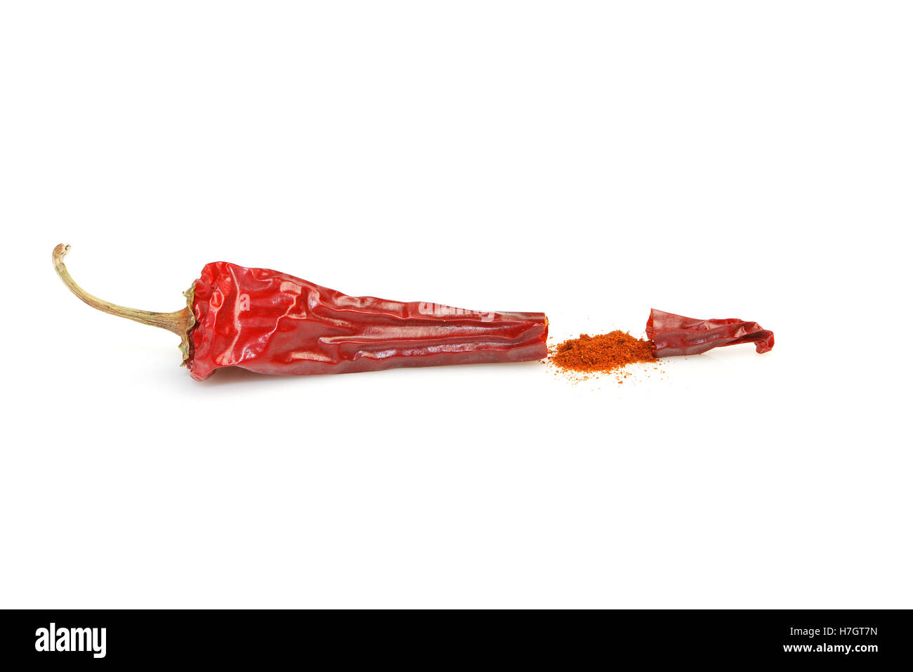 Hot red paprika on white background, cut and filled with powdered spice ...