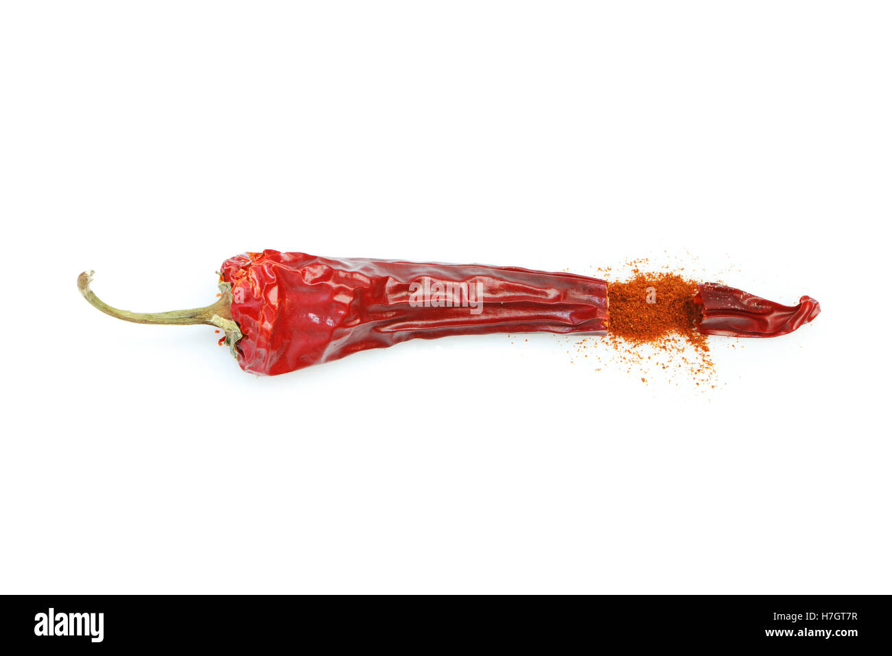 Hot red paprika on white background, cut and filled with powdered spice ...