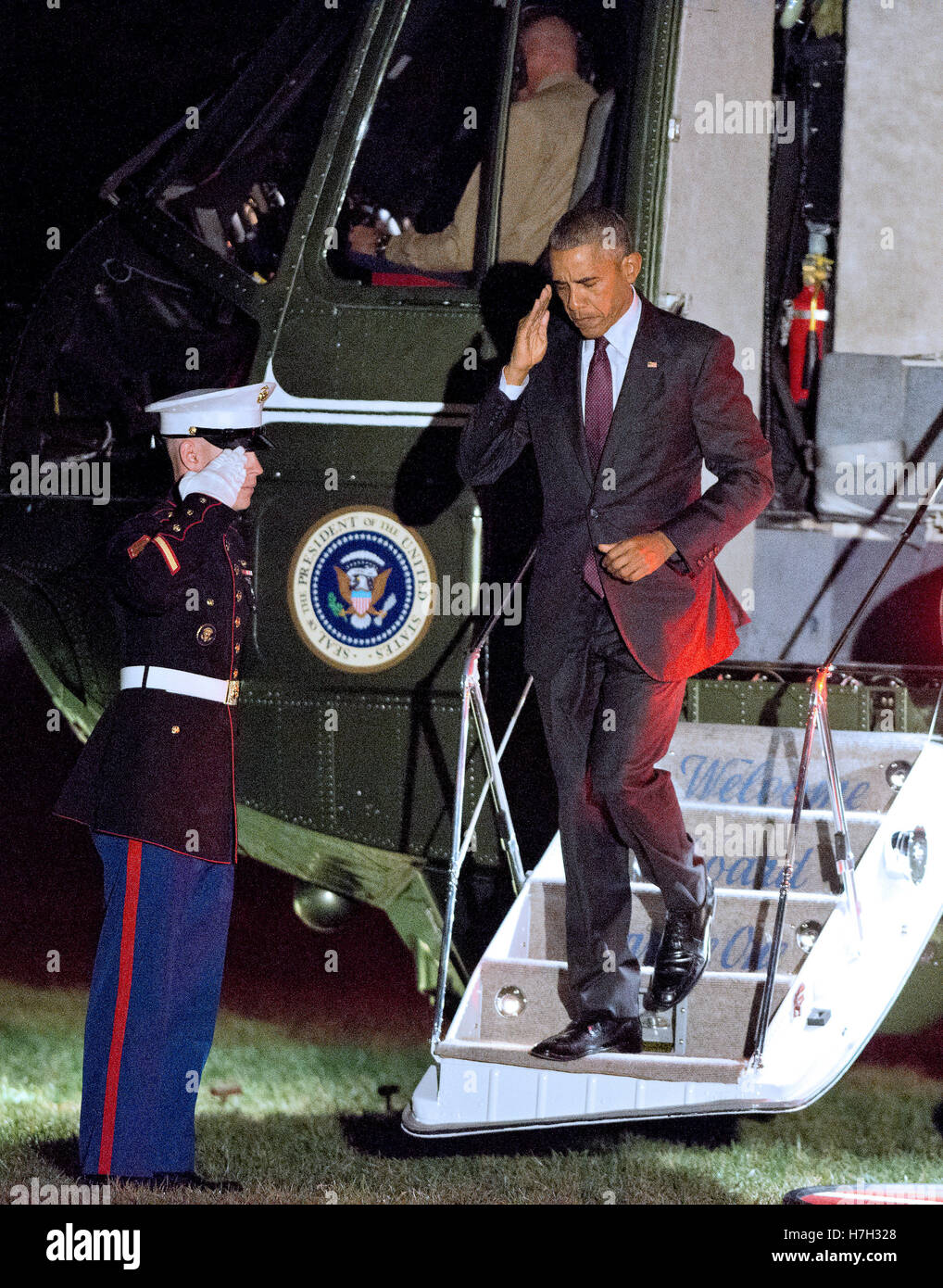 United States President Barack Obama salutes the Marine Guard as he ...
