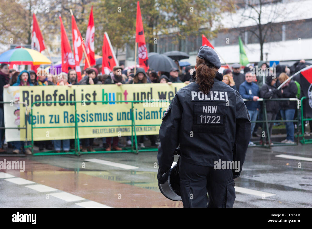 A female German police officer stands in-front of left-wing ...