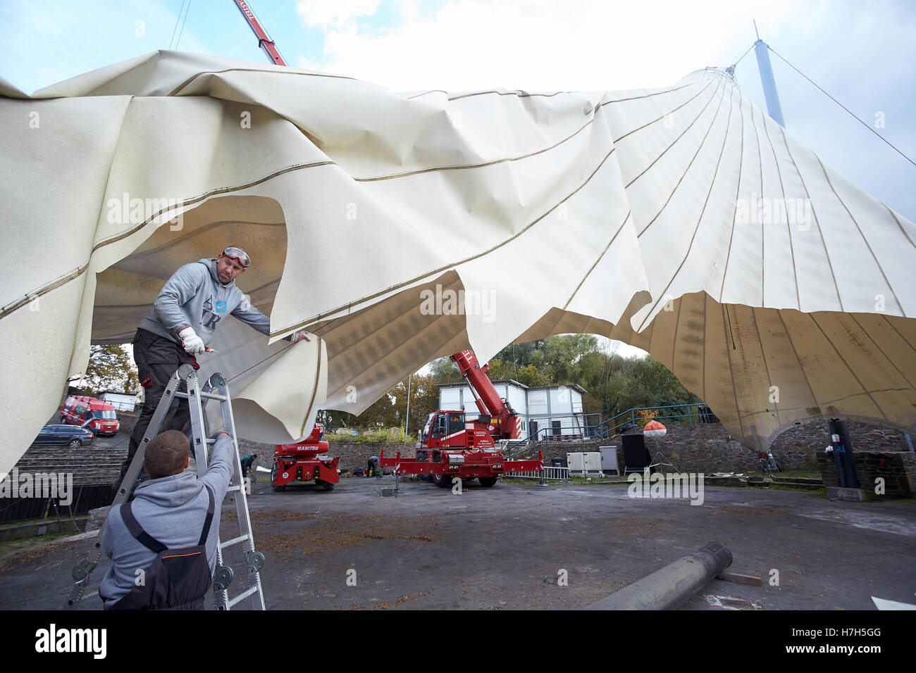 Workers pull down the tent roof of the open-air stage Loreley in St ...