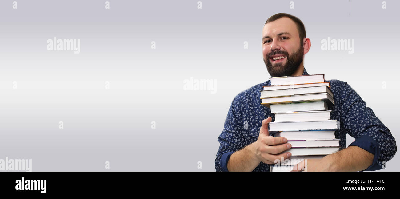 student adult beard man with stack of book Stock Photo - Alamy