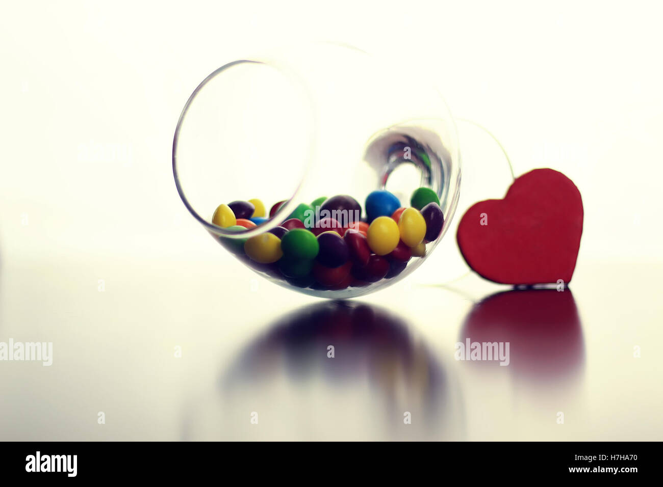 glass with candy pill Stock Photo - Alamy