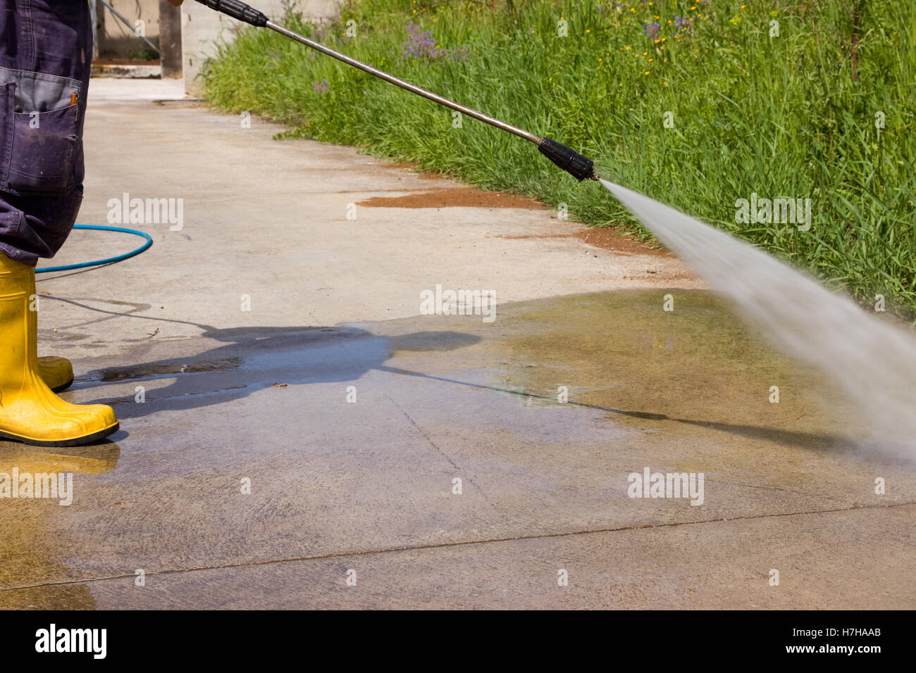 worker cleaning industrial site with a pressure washer Stock Photo - Alamy