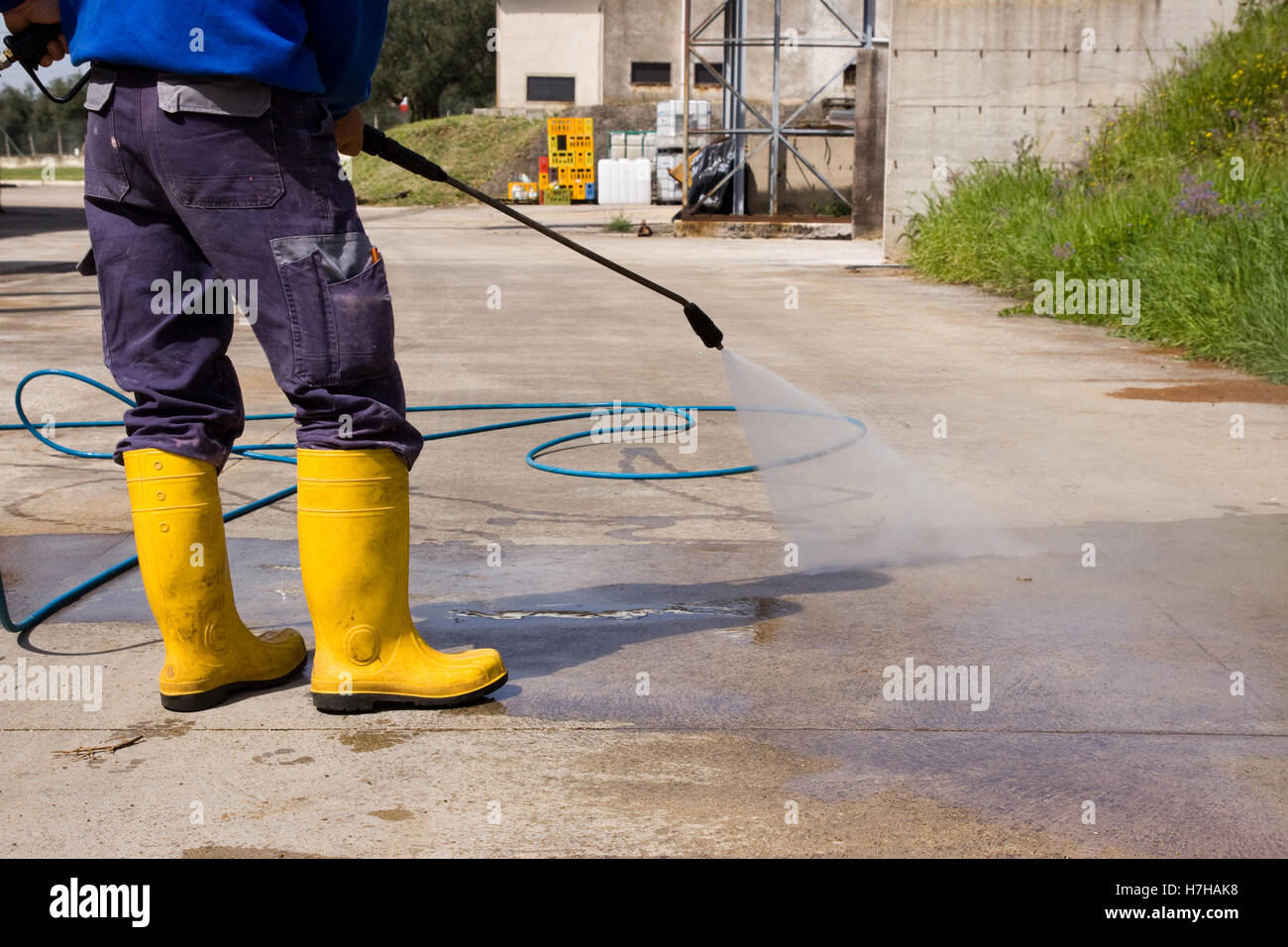 worker cleaning industrial site with a pressure washer Stock Photo - Alamy